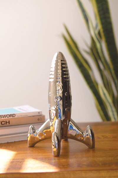 silver ceramic rocket sculpture