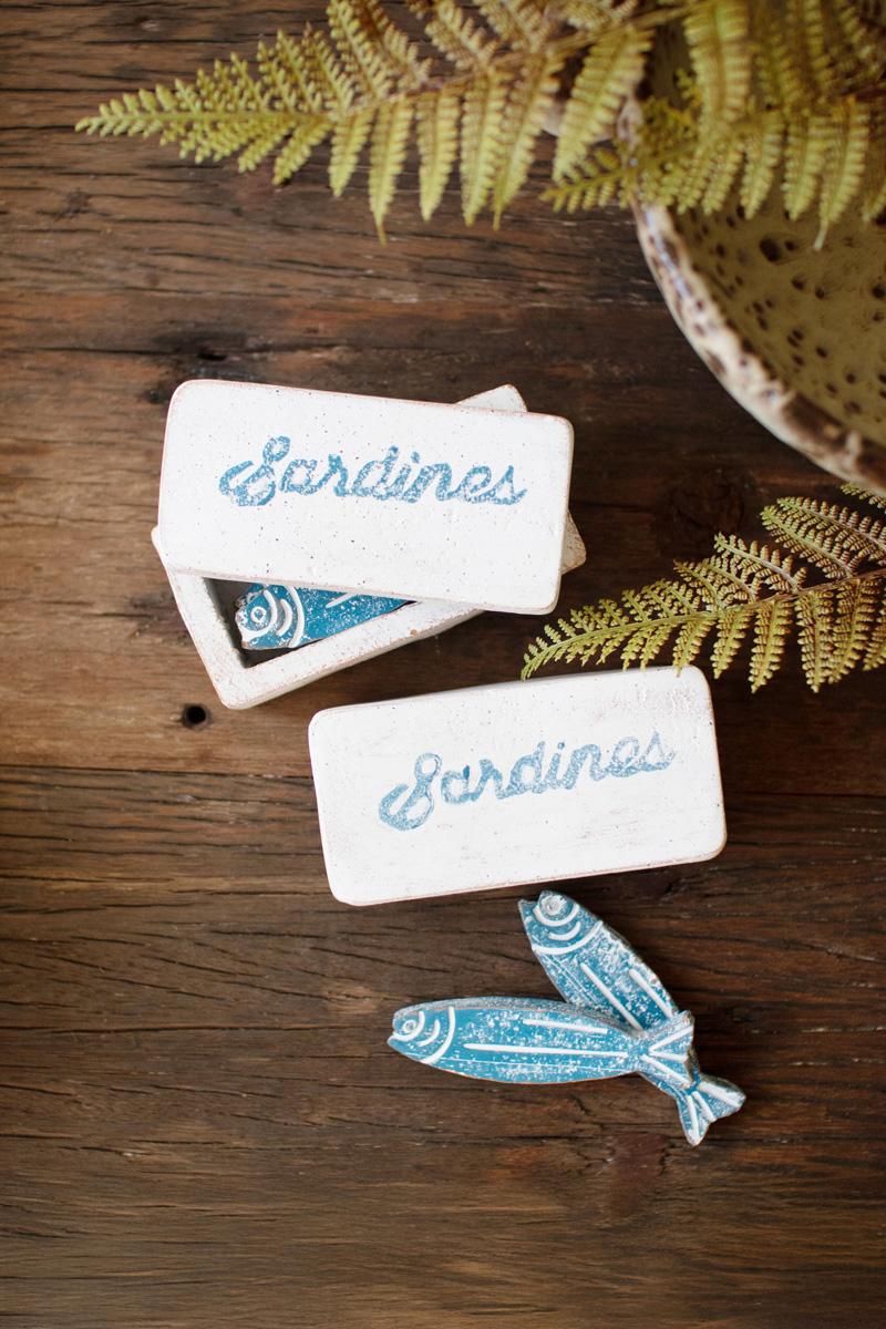 painted clay sardines in a box