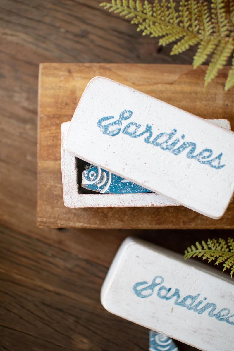 painted clay sardines in a box