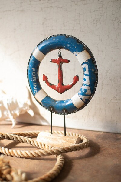 recycled iron life preserver with anchor on a stand